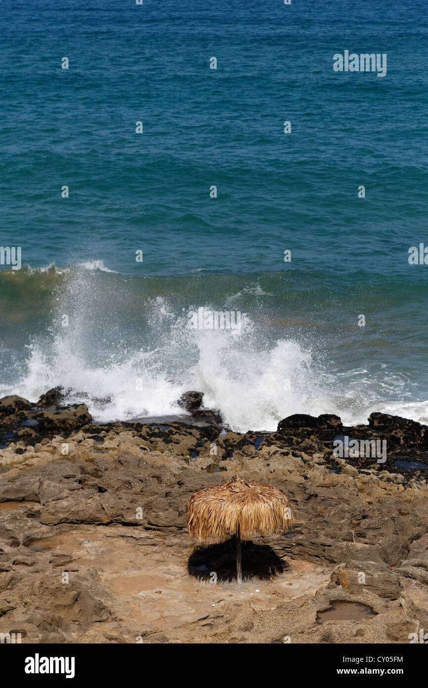 Parasol made of straw on the coast of the Atlantic Ocean, Tangier ...