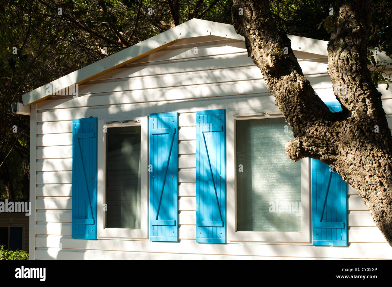 White bungalow and tree close up Stock Photo - Alamy