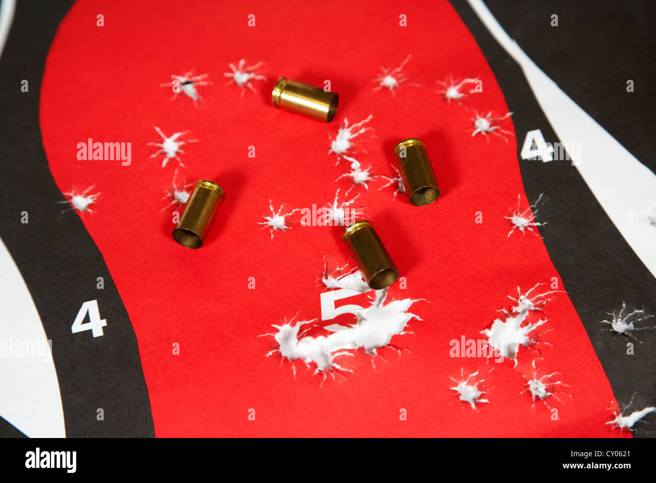 human shaped target ridden with bullet holes and 9mm empty shell ...