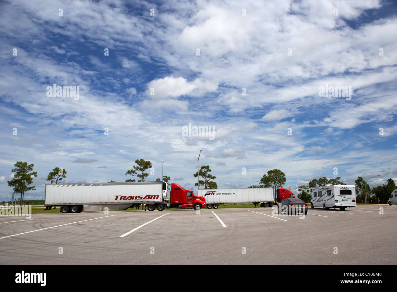 trucks and cars in the parking lot of an interstate rest service stop ...