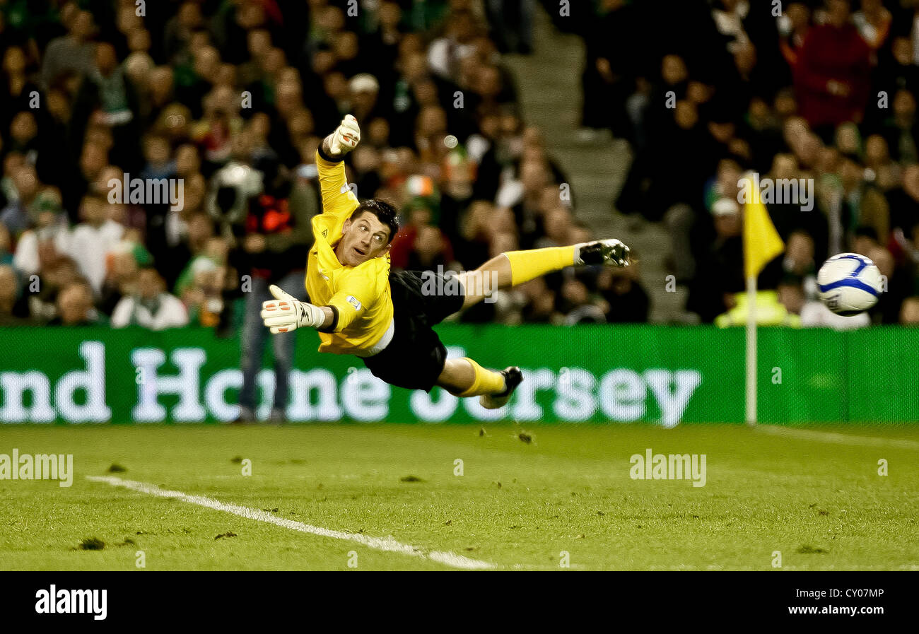 The Irish goalkeeper Keiren Westwood looks at the ball flying into the ...