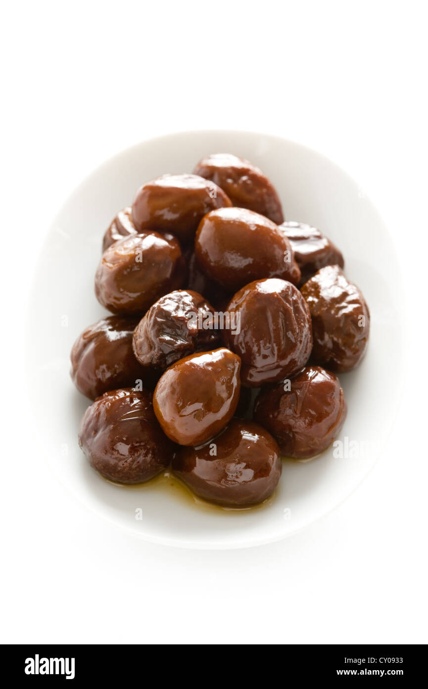 canned prunes on a white dish isolated Stock Photo - Alamy