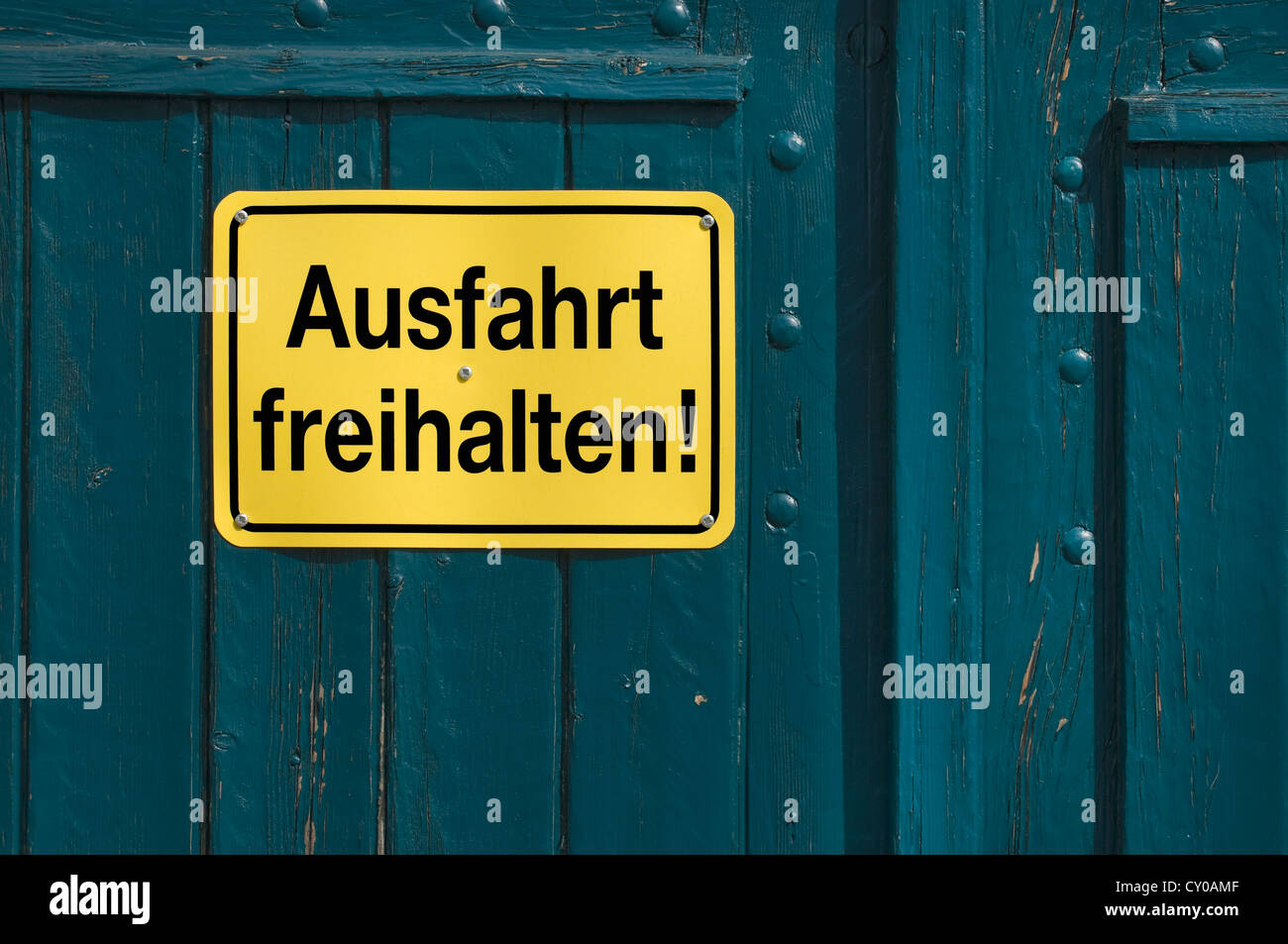 Sign lettering "Ausfahrt freihalten", German for "Keep driveway clear ...