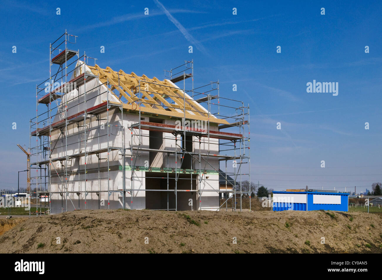 House construction site, building shell surrounded with scaffolding ...