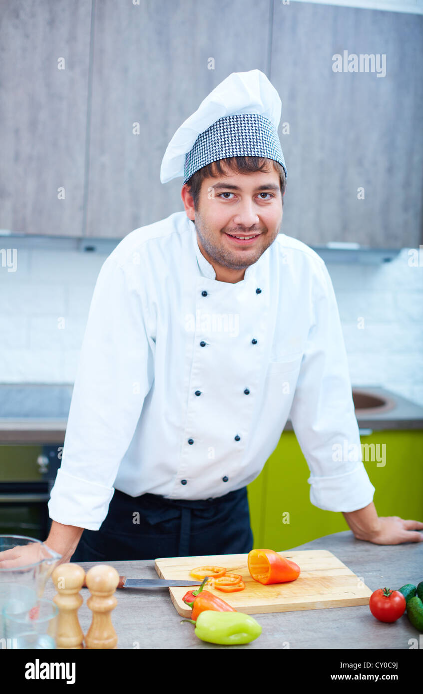 Portrait of handsome man in cook uniform looking at camera Stock Photo ...
