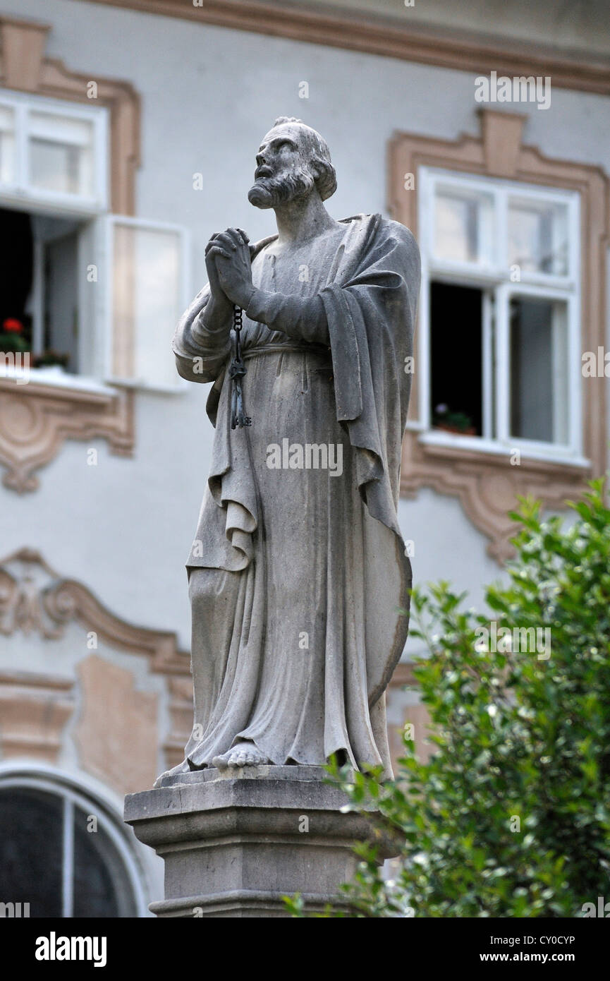 Statue of a man praying in the yard of St Peter's Archabbey, Sankt ...