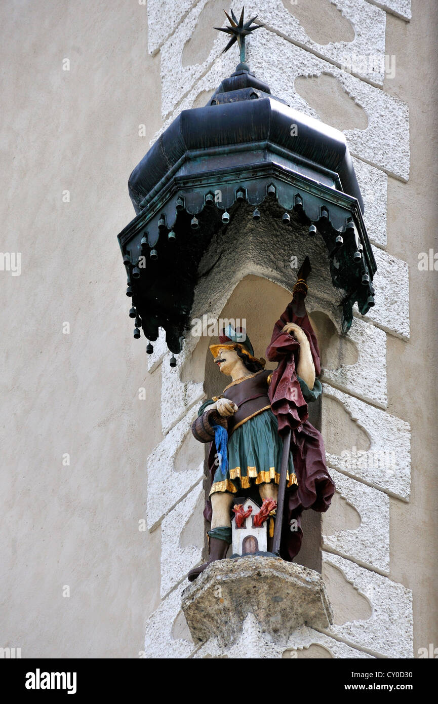 Coloured statue of St. Florian under a baldachin on a corner ...