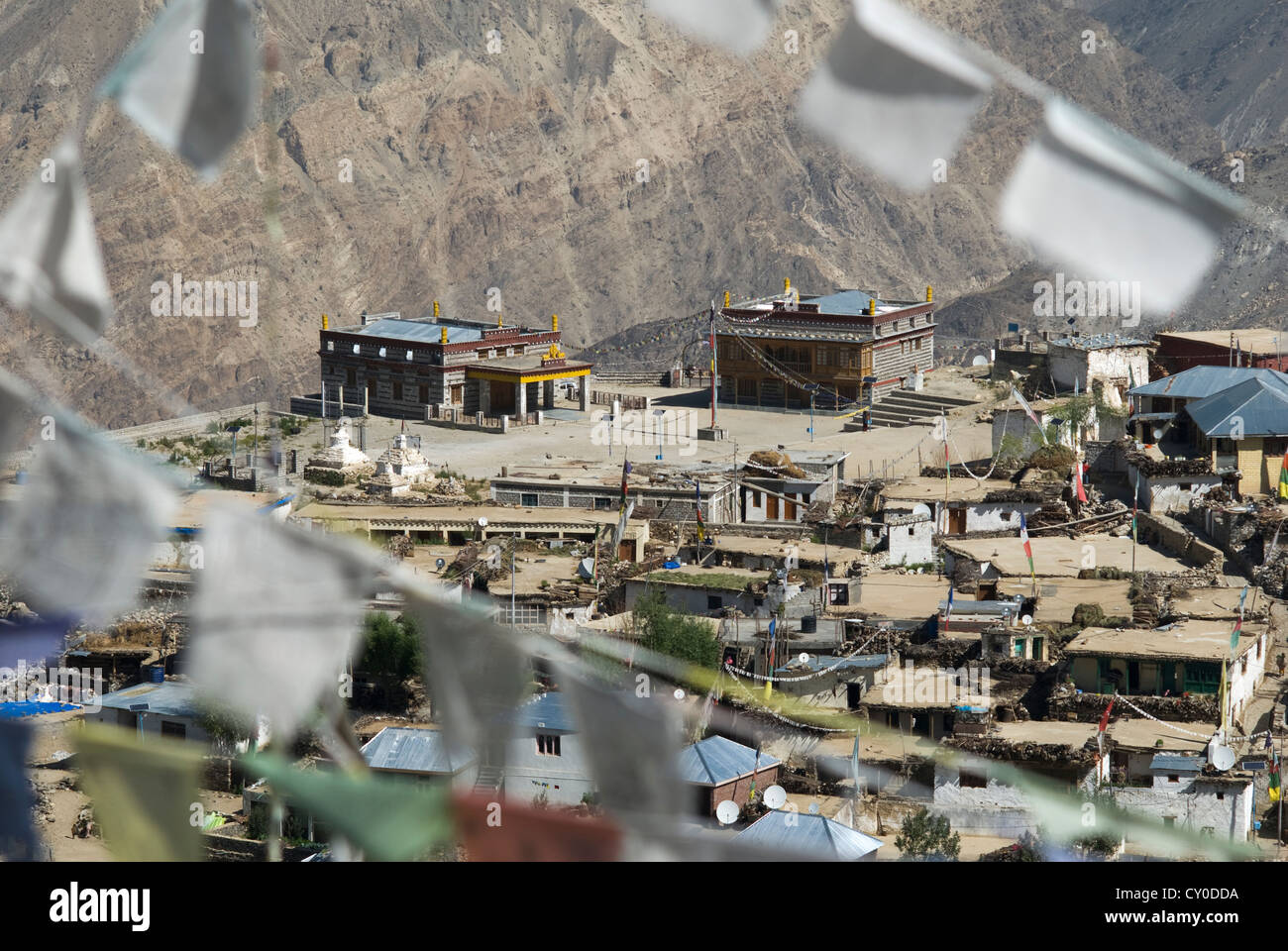 Prayerflags from a hilltop shrine frame Nako Monastery in the Kinnaur ...