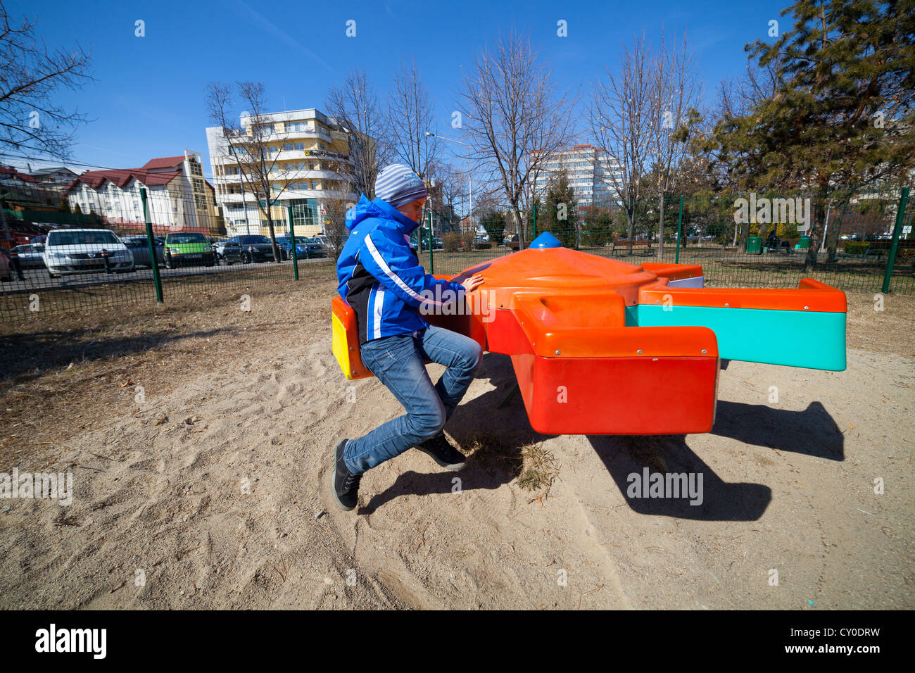 Full length portrait of a child spinning on a carousel Stock Photo - Alamy