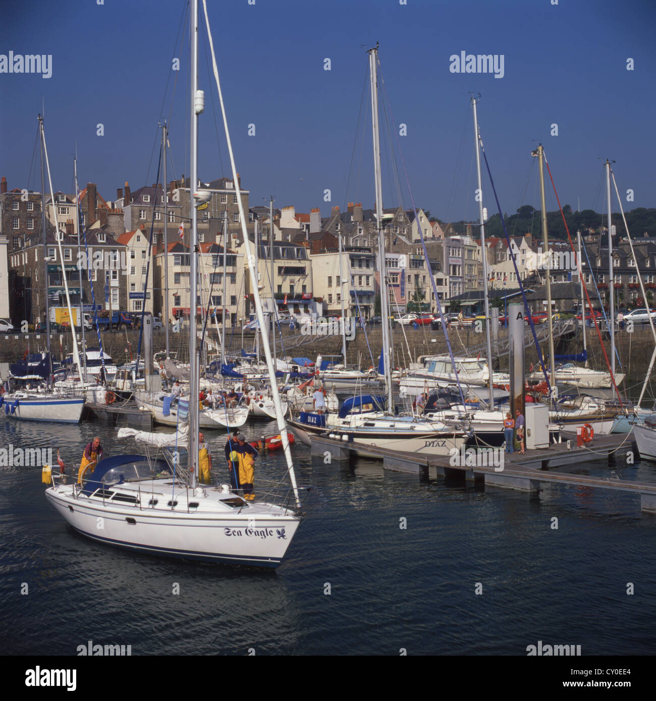 Harbour scene with yacht leaving Stock Photo - Alamy