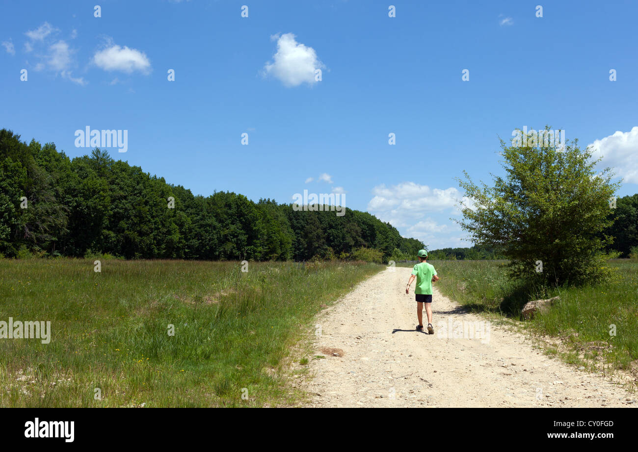 Child walking on a rural road in the summertime Stock Photo - Alamy