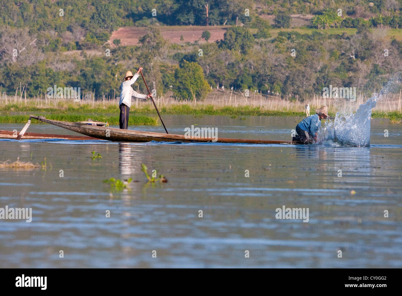 Myanmar, Burma. Fisherman Slapping the Water with his Paddle to Stun ...