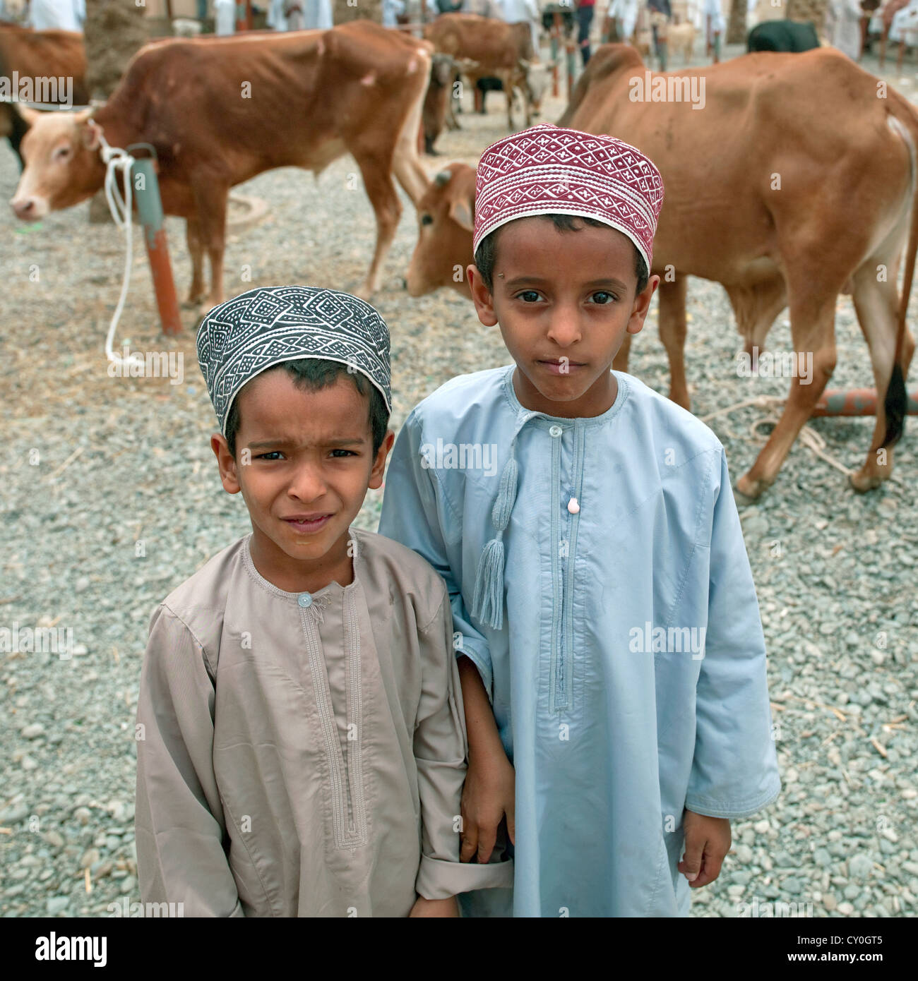 Two Kids In Traditional Costumes At Nizwa Market, Oman Stock Photo - Alamy