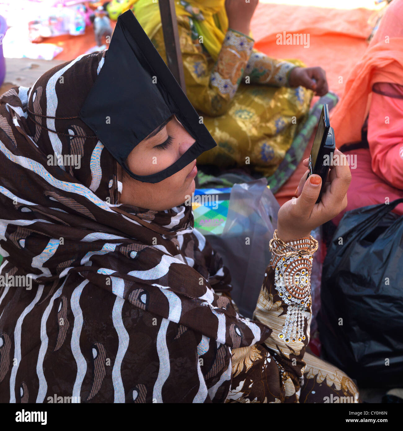 Bedouin Woman Looking At Her Mobile Phone, Ibra, Oman Stock Photo - Alamy