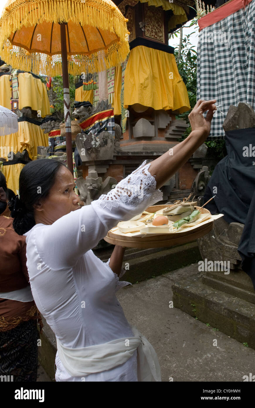 A family member performs protection rites at a funerary ceremony in ...