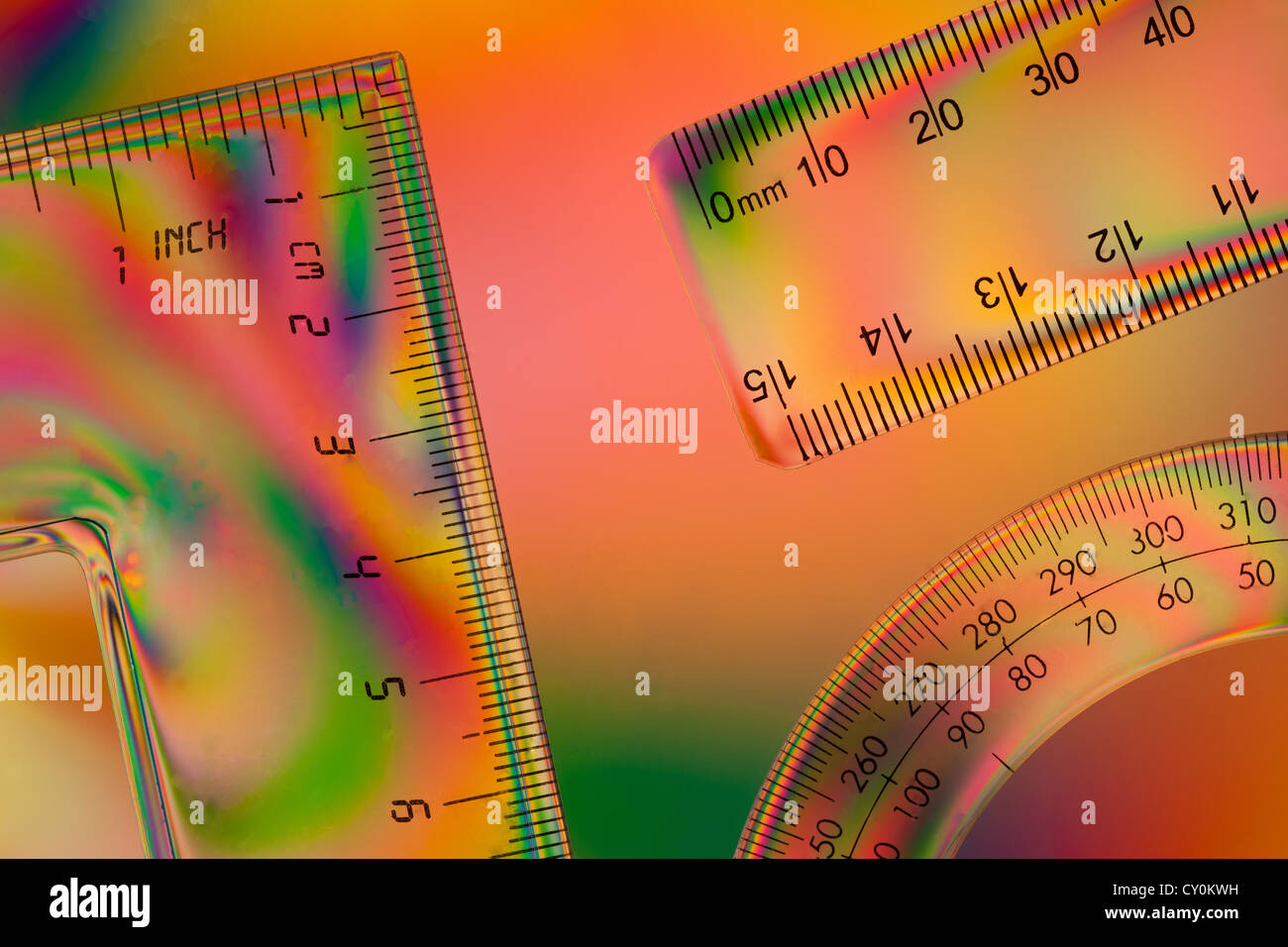 Scales on a ruler,set square and protractor against a colourful double ...