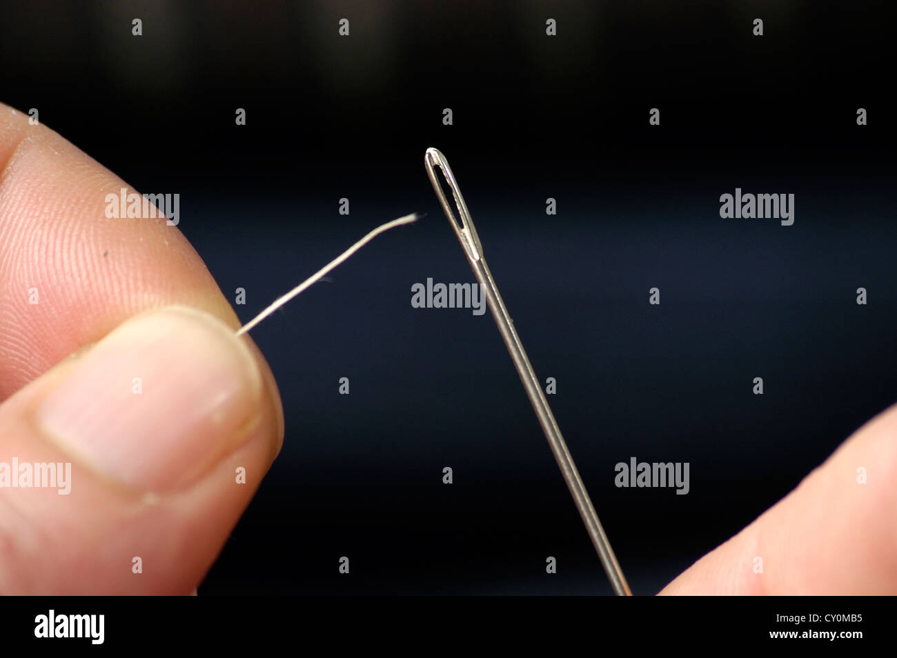 Threading a Needle Stock Photo - Alamy