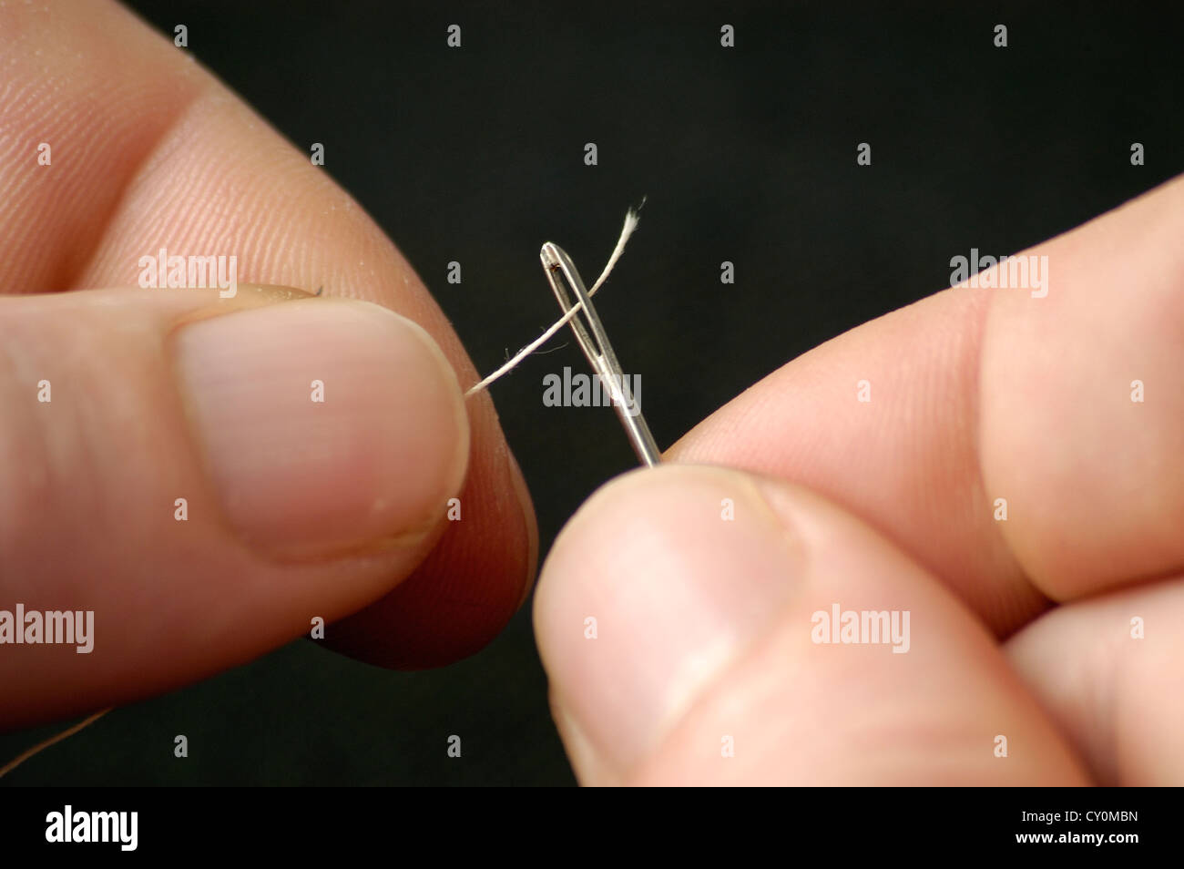 Threading a Needle Stock Photo - Alamy