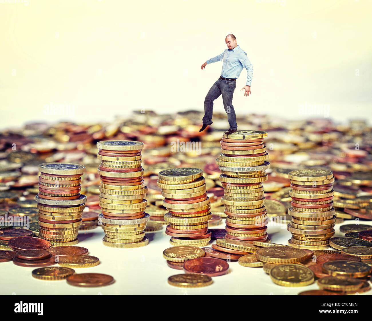 businessman walk on euro coin piles Stock Photo - Alamy