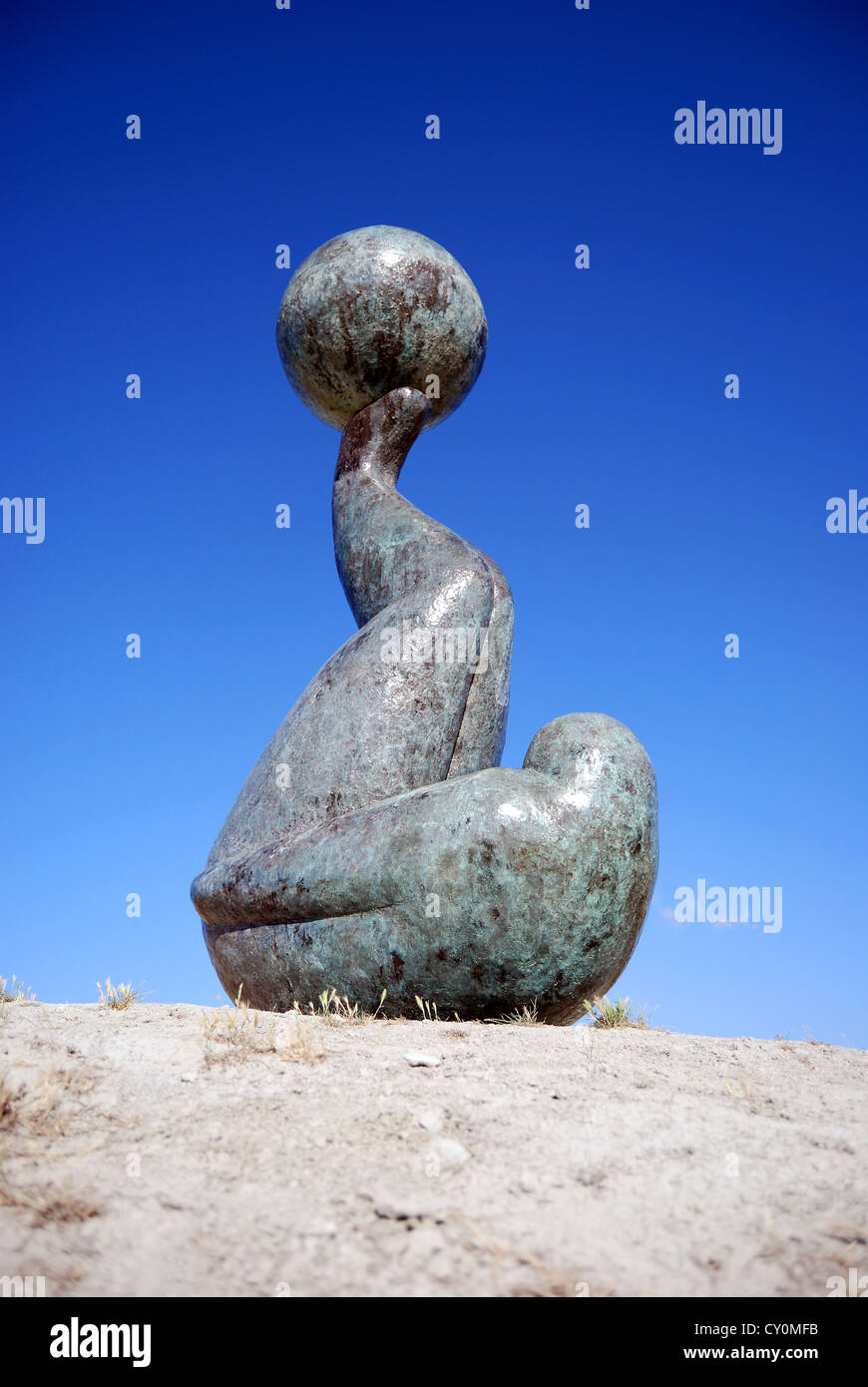 Statue of Man Balancing Ball on Feet Stock Photo - Alamy