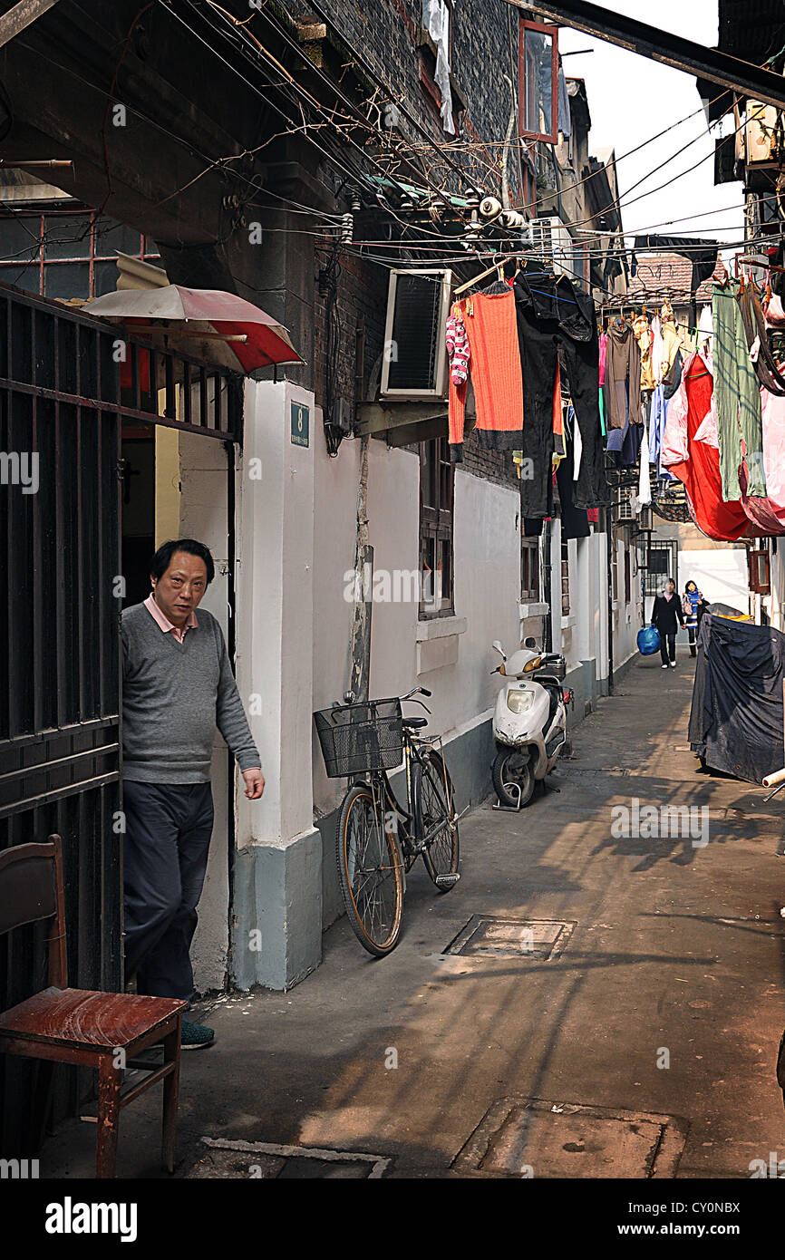 Chinese man in a lilong (traditional housing of Shanghai, equivalent of ...