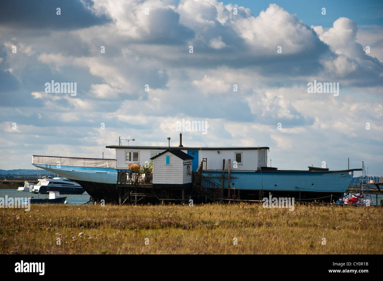 Old sailing ship converted to houseboat Stock Photo - Alamy