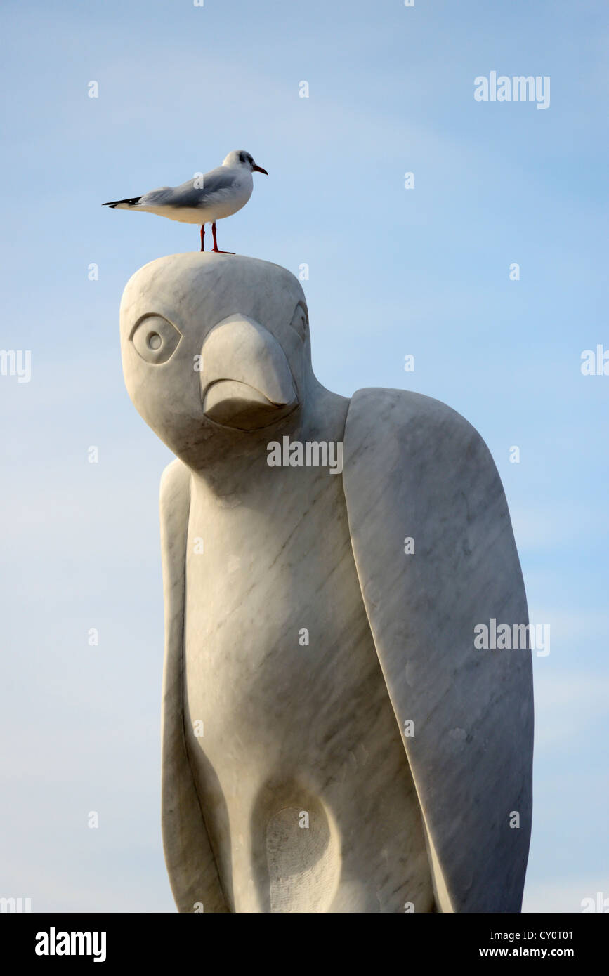 Seagull perching on 'Mythical South American Bird' sculpture. The Tern ...