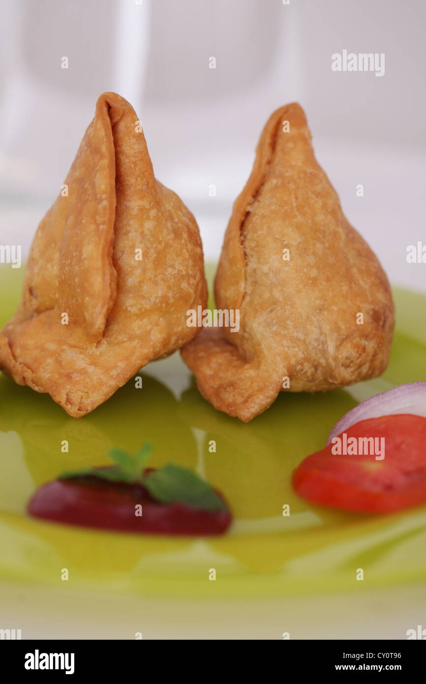Samosa is an Inidan fried or baked pastry with a savory filling, such ...