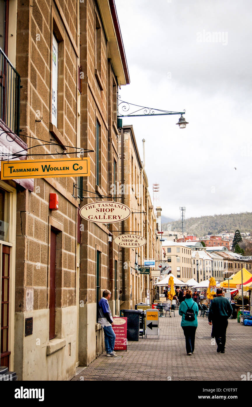 People near shops & restaurants in historical sandstone buildings at ...