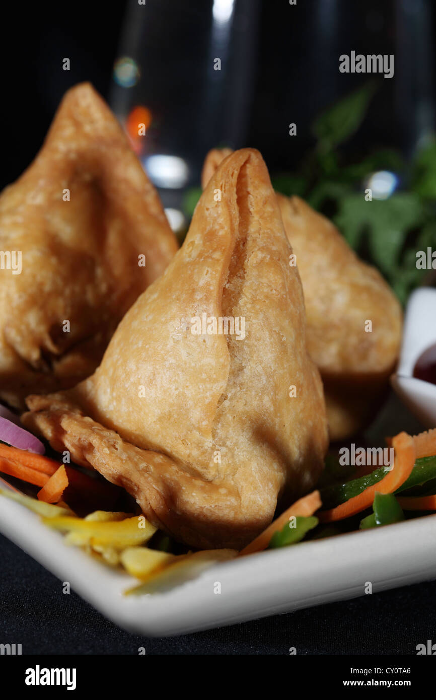 Samosa is an Inidan fried or baked pastry with a savory filling, such ...
