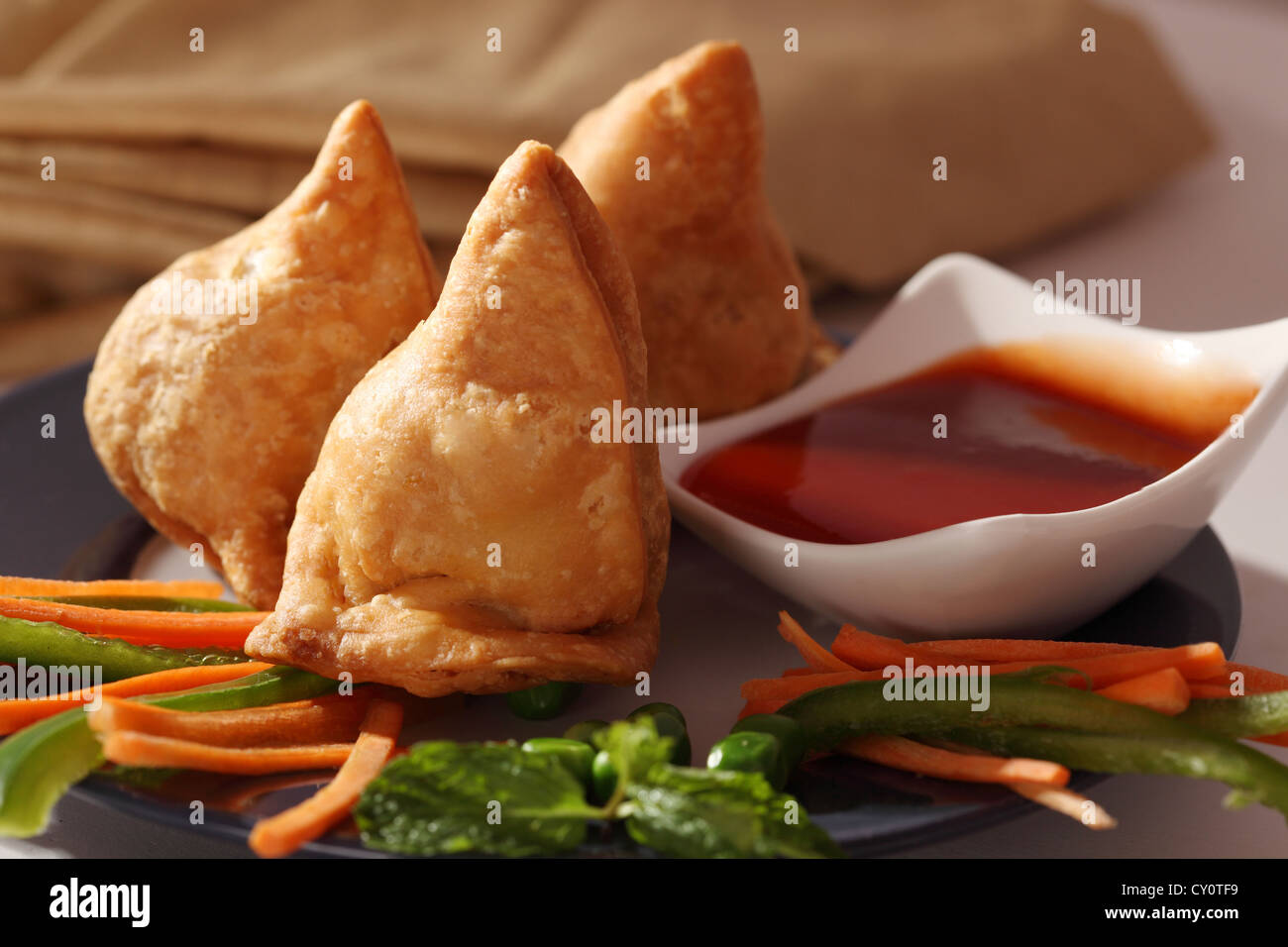 Samosa is an Inidan fried or baked pastry with a savory filling, such ...
