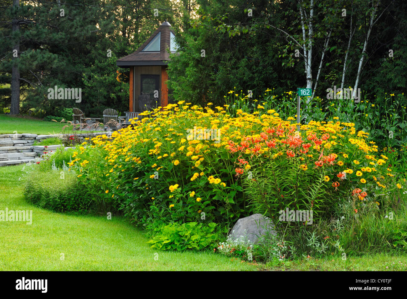 Naturalized garden meadow near formal lawns and stone walls, Greater ...