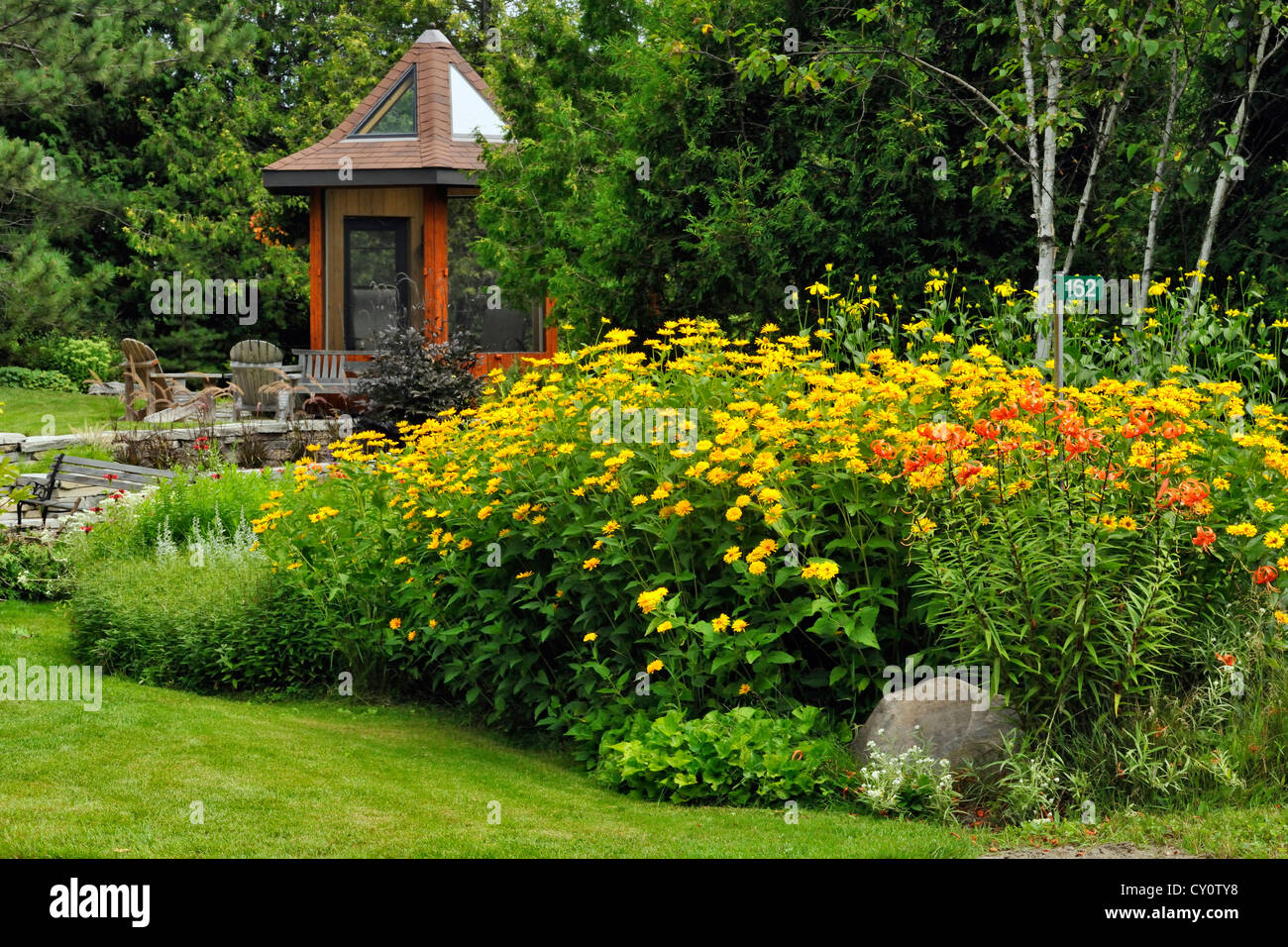 Naturalized garden meadow near formal lawns and stone walls, Greater ...