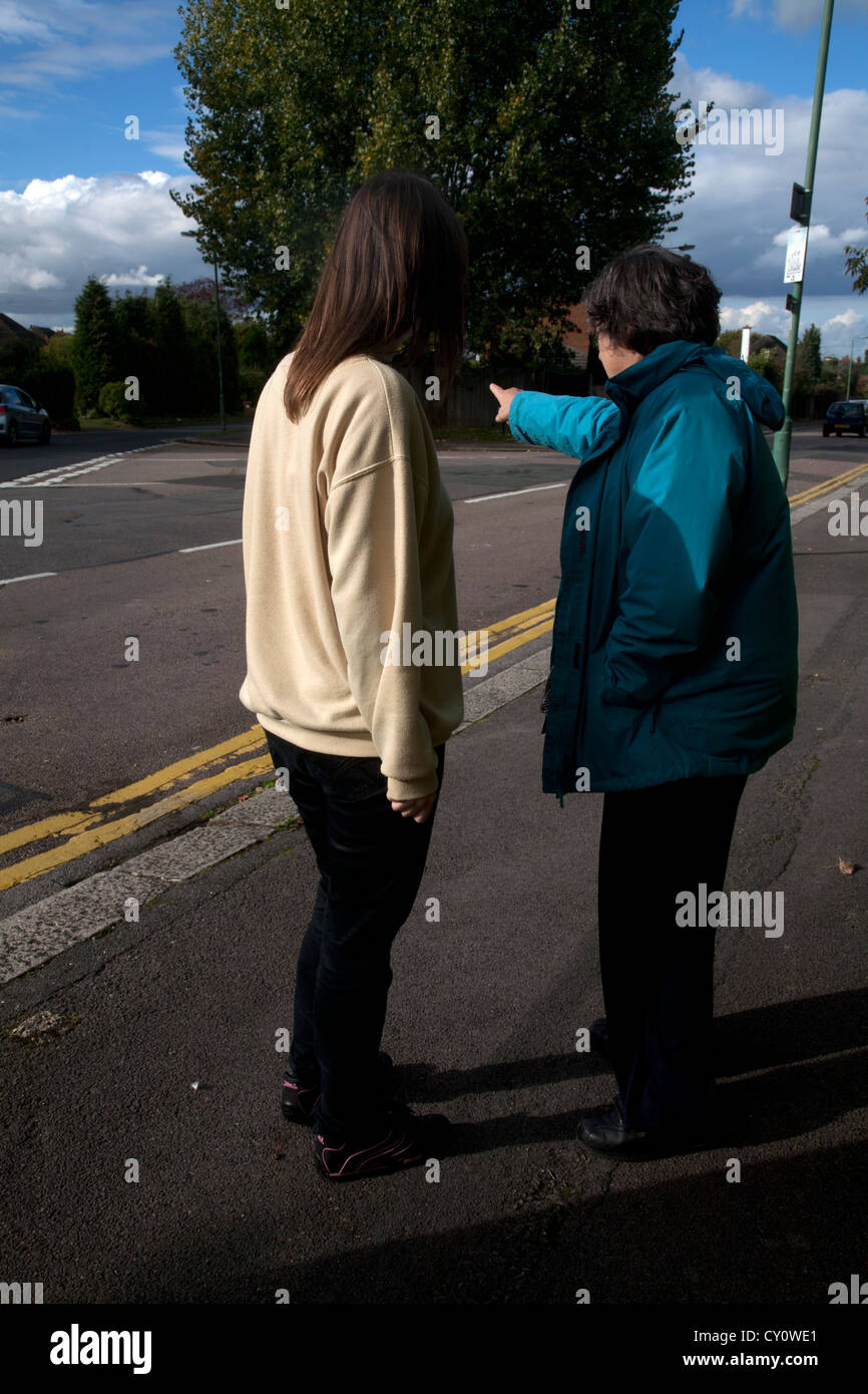 Woman pointing in the street and giving directions to another woman ...