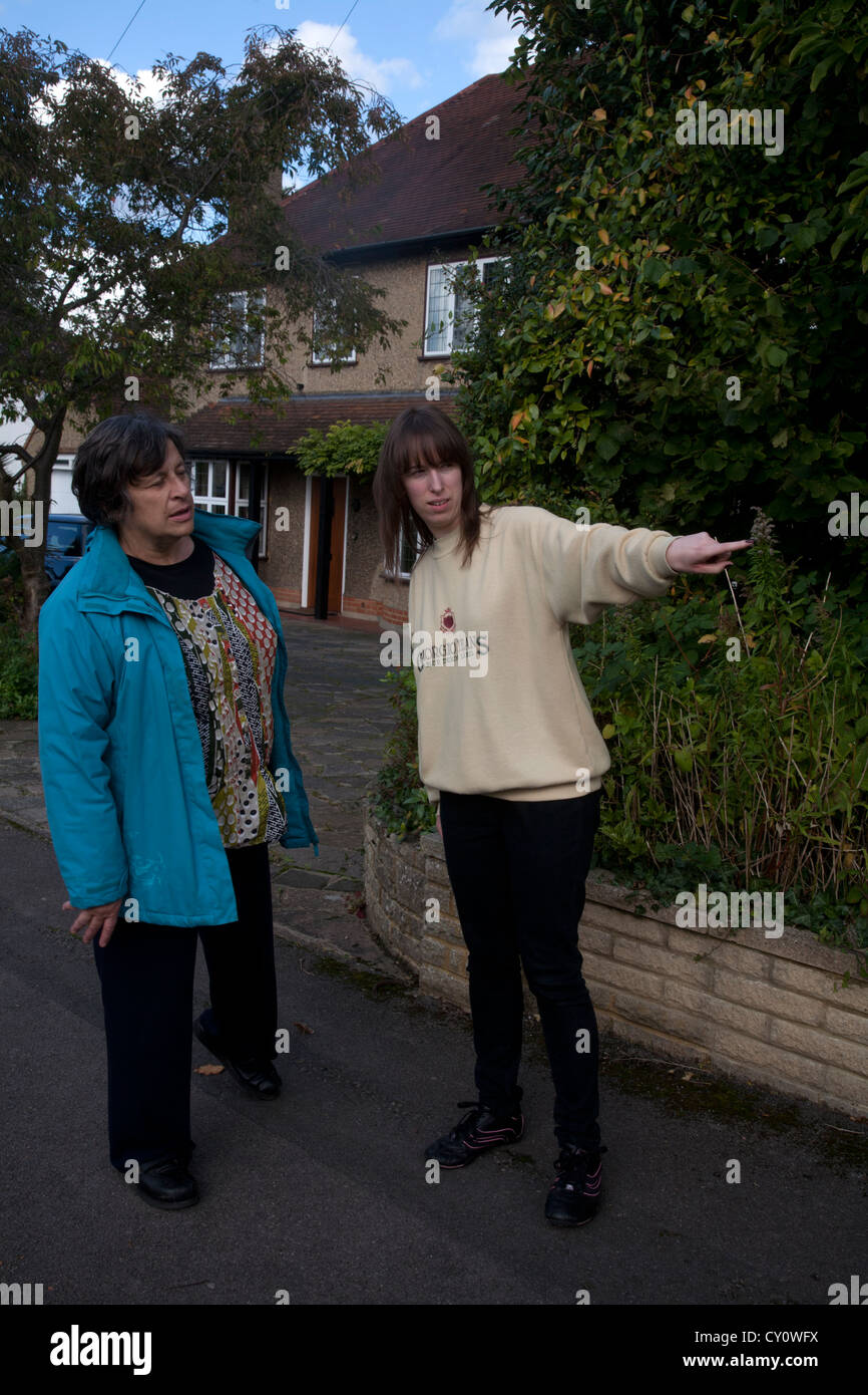 Woman pointing in the street and giving directions to another woman ...