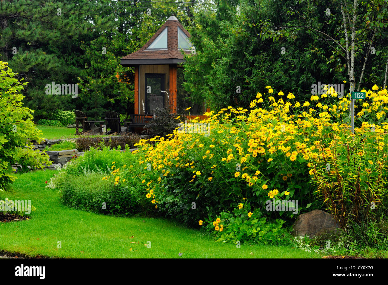 Naturalized garden meadow near formal lawns and stone walls, Greater ...
