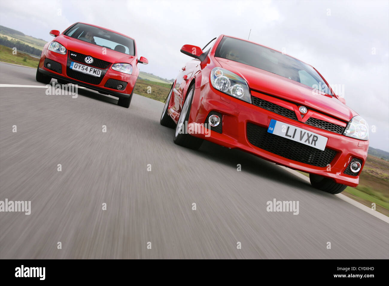 Two hot hatch cars driving on road Stock Photo - Alamy