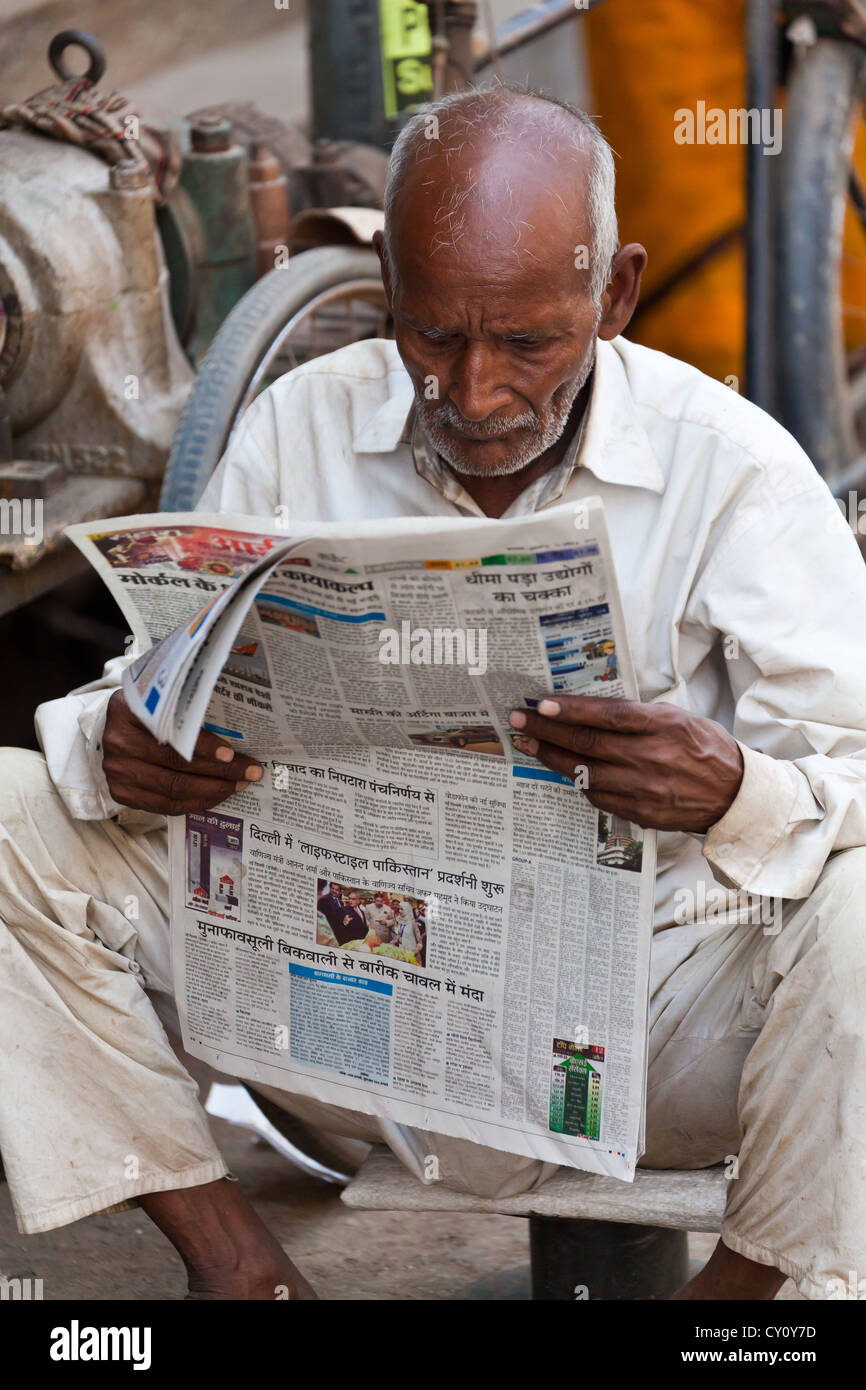 Man reading a Newspaper on the Street in Varanasi, India Stock Photo ...