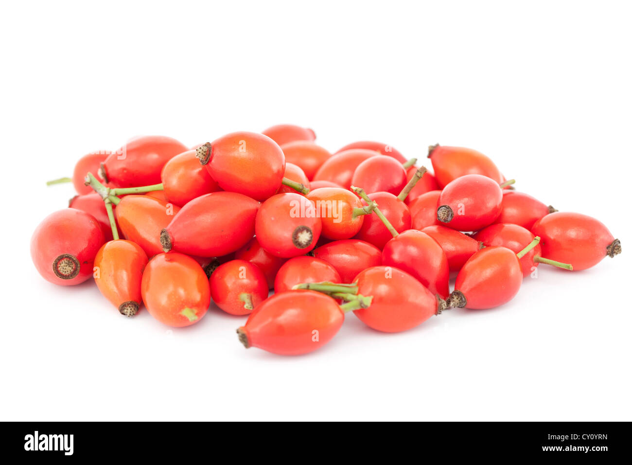 heap of red fruit rose on white background Stock Photo - Alamy