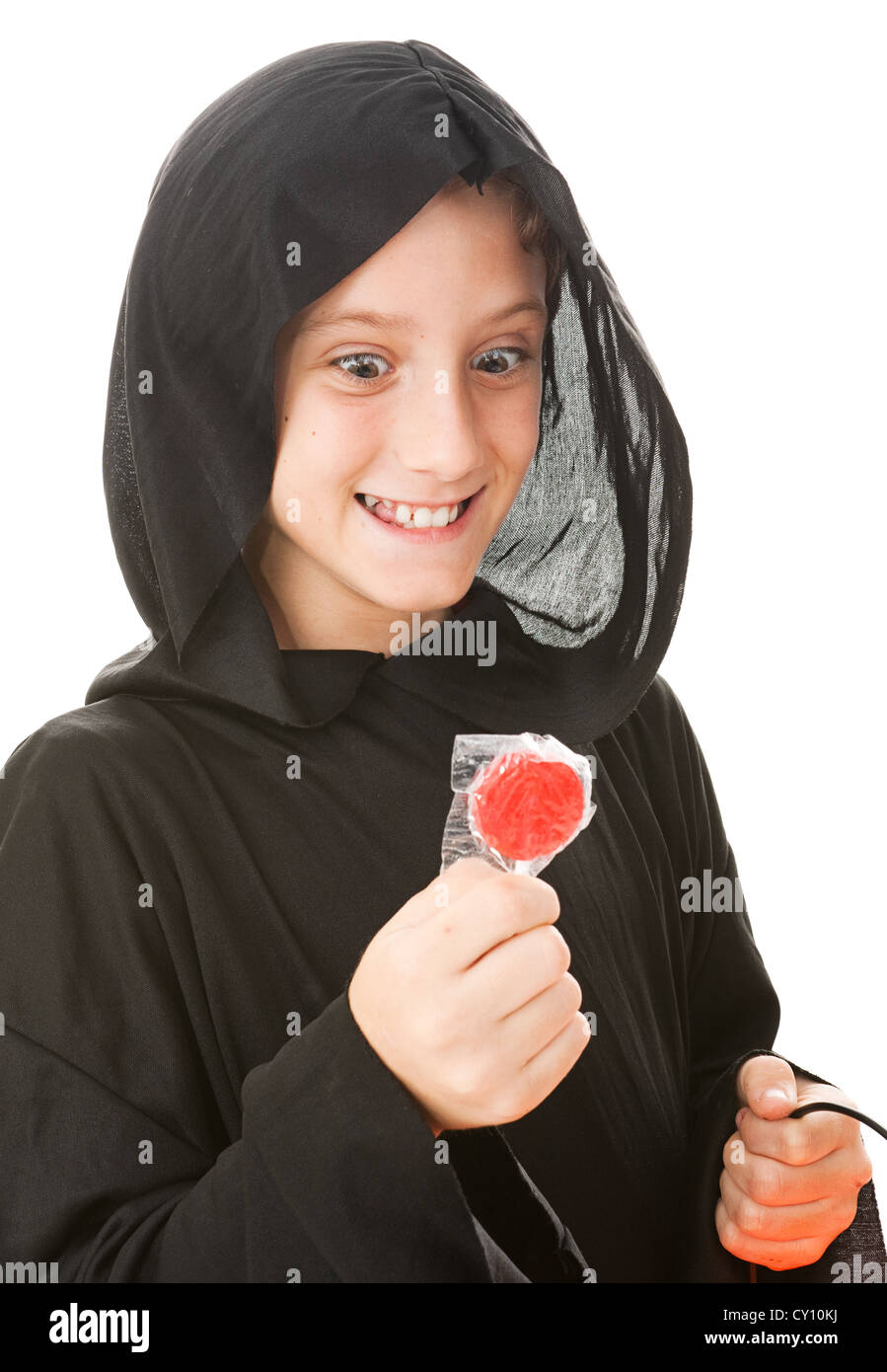 Little boy dressed in his halloween costume, looking hungrily at a ...