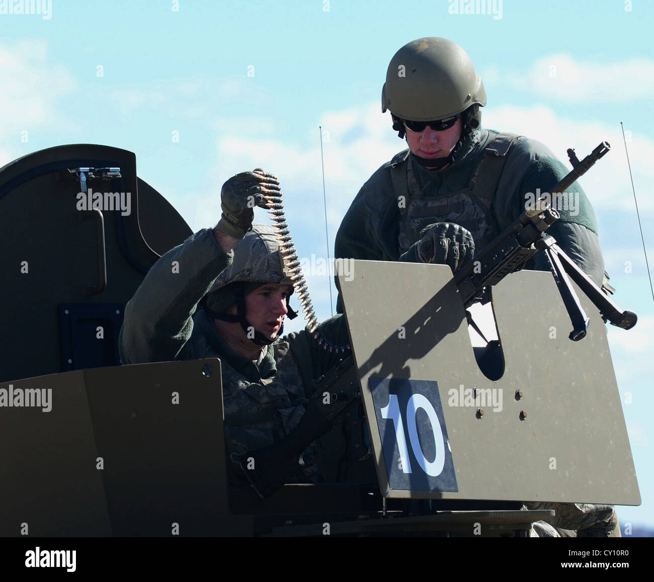 Staff Sgt. Jordan Gaddis instructs an Airman in practice firing from a ...