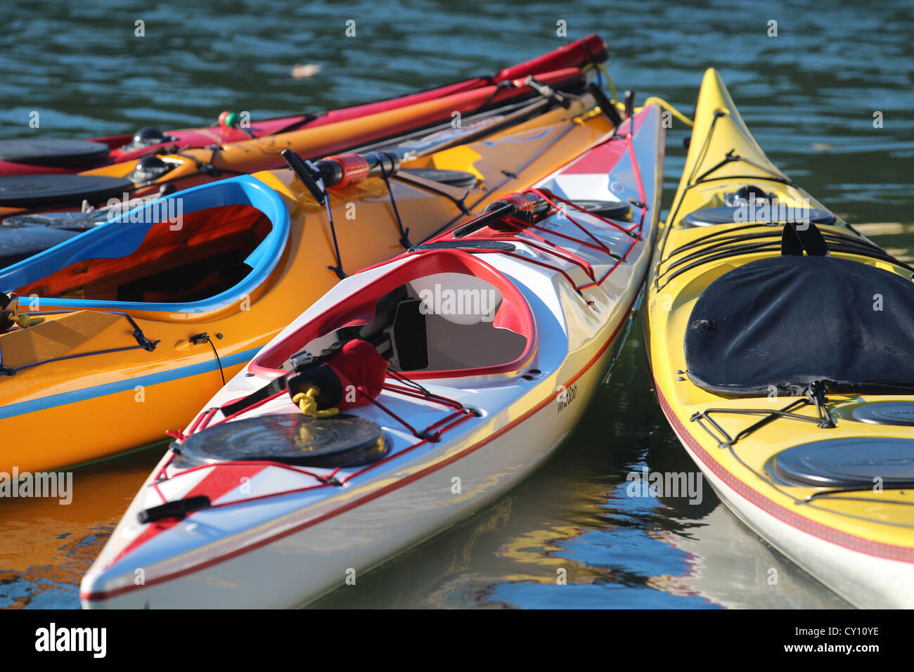 Three kayaks sitting in the water Stock Photo - Alamy