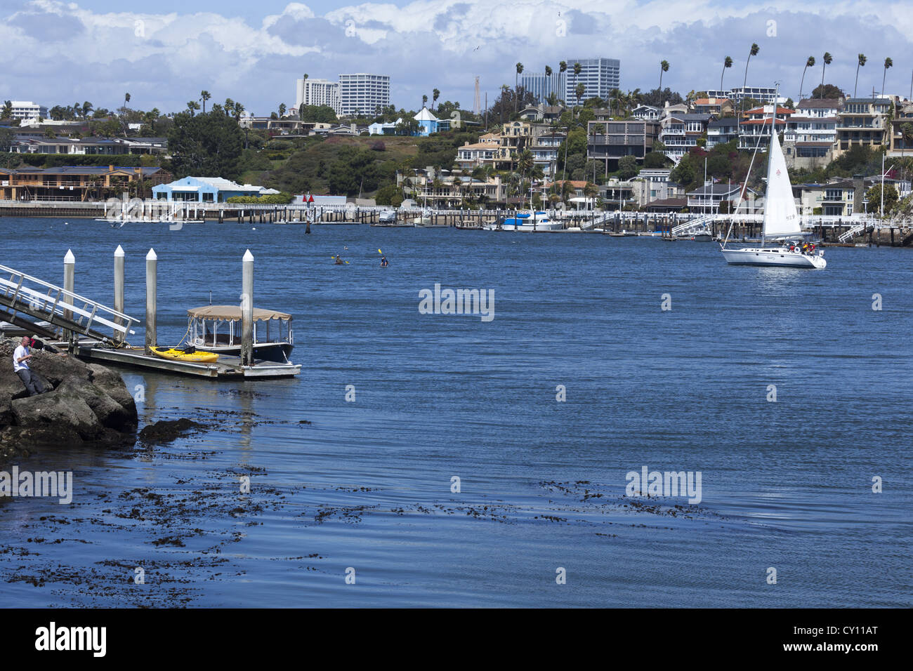 Waterfront houses. Idyllic. Sailboat entering Newport Harbor Southern ...