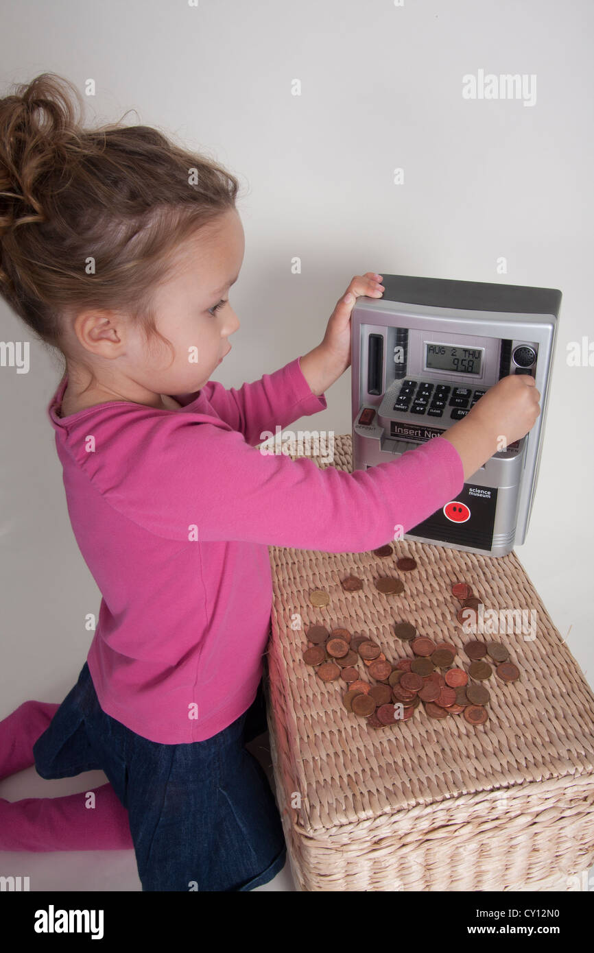 little girl playing on toy cash register Stock Photo - Alamy