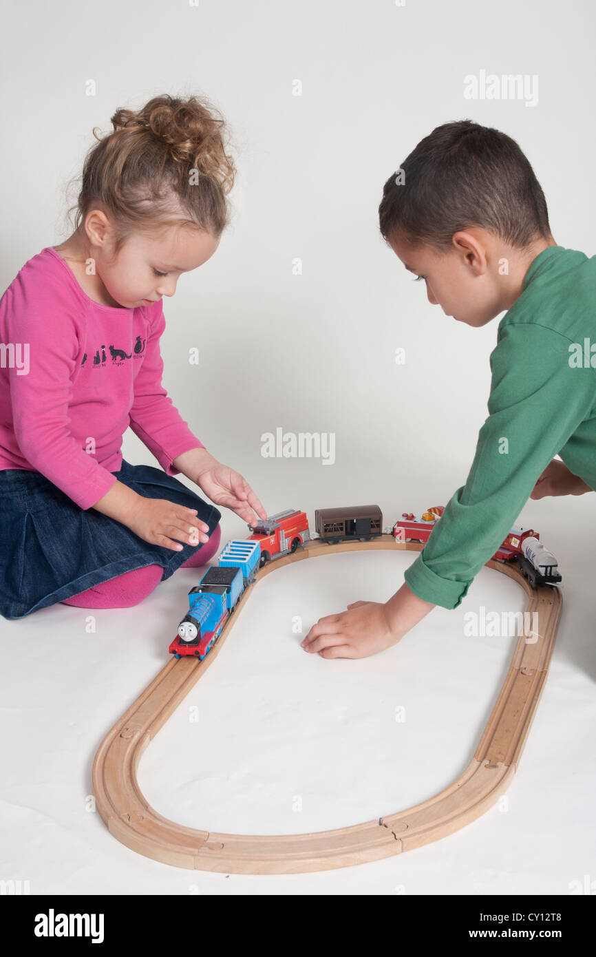 children playing with train set Stock Photo - Alamy