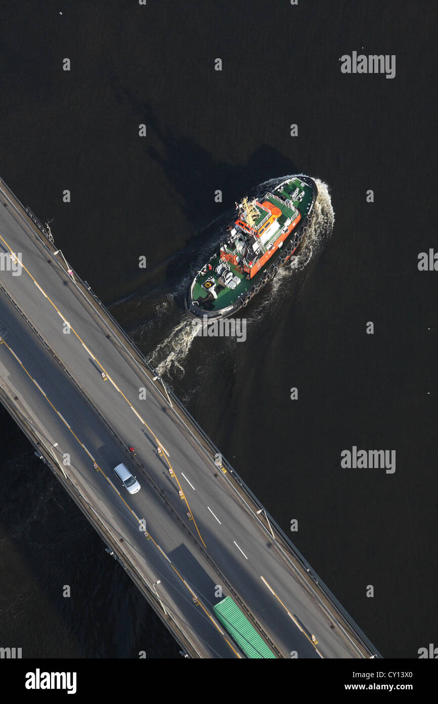 aerial view of a small boat sailing under a road bridge in Hamburg ...
