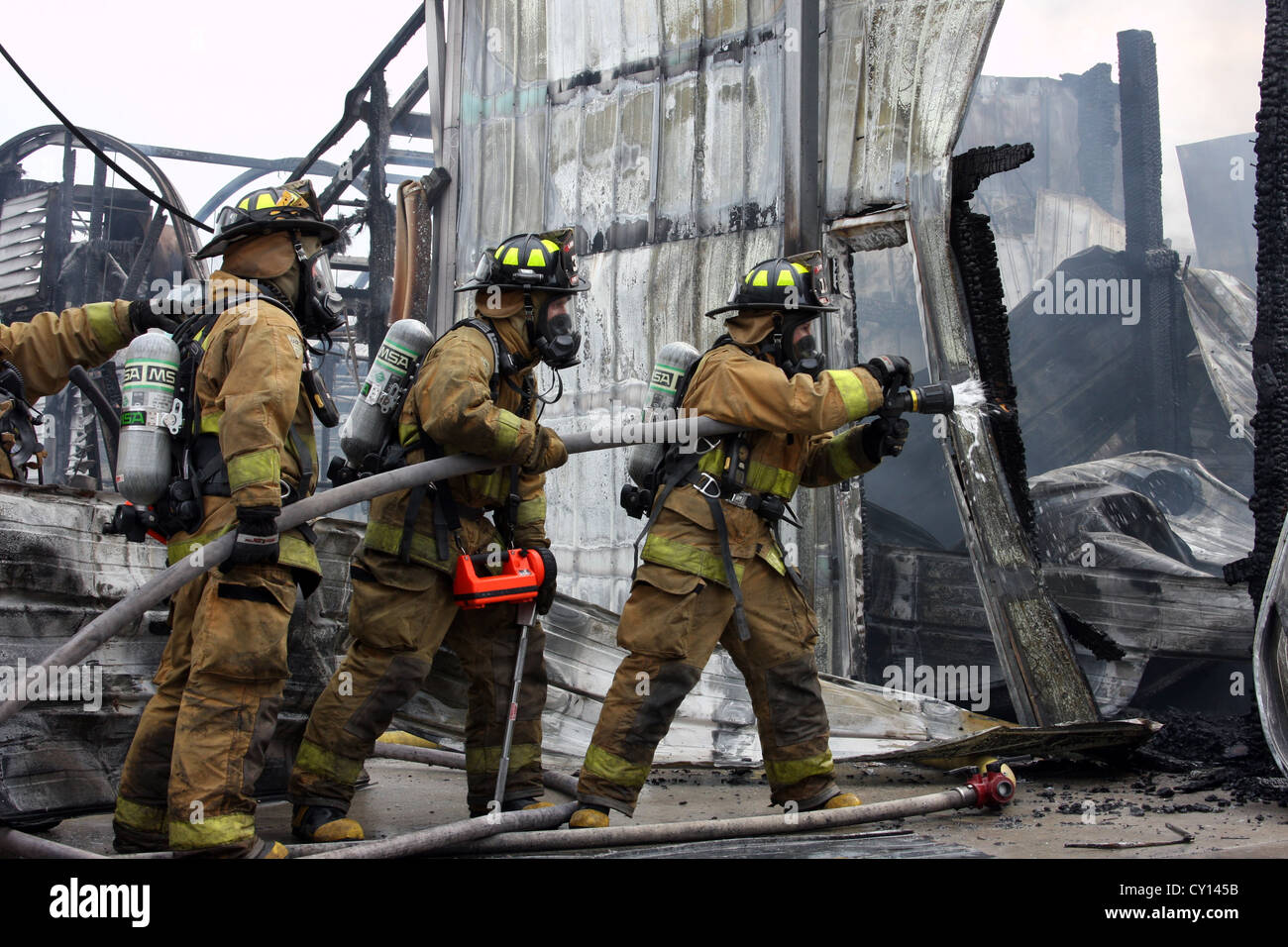 Firefighters about to put water on an industrial fire Stock Photo - Alamy