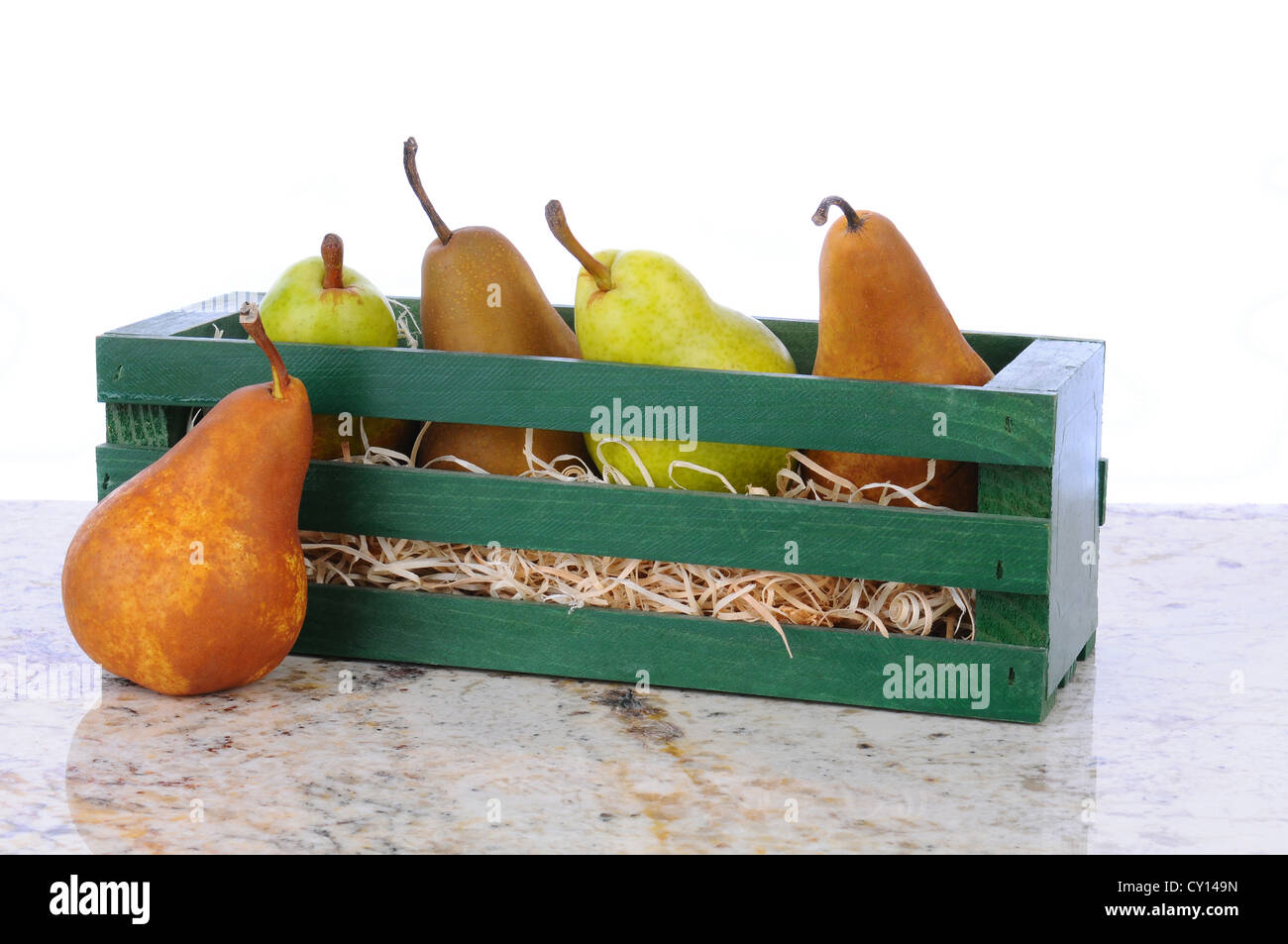 Bartlett and Bosc pears in a wooden crate on a granite counter top ...