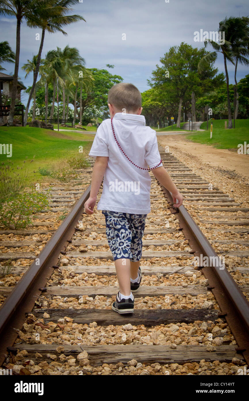 A Five year old Autistic Boy Tensely Walks Away Down Railroad Tracks A Five year old Autistic Boy Tensely Walks Away Down Railroad Tracks
