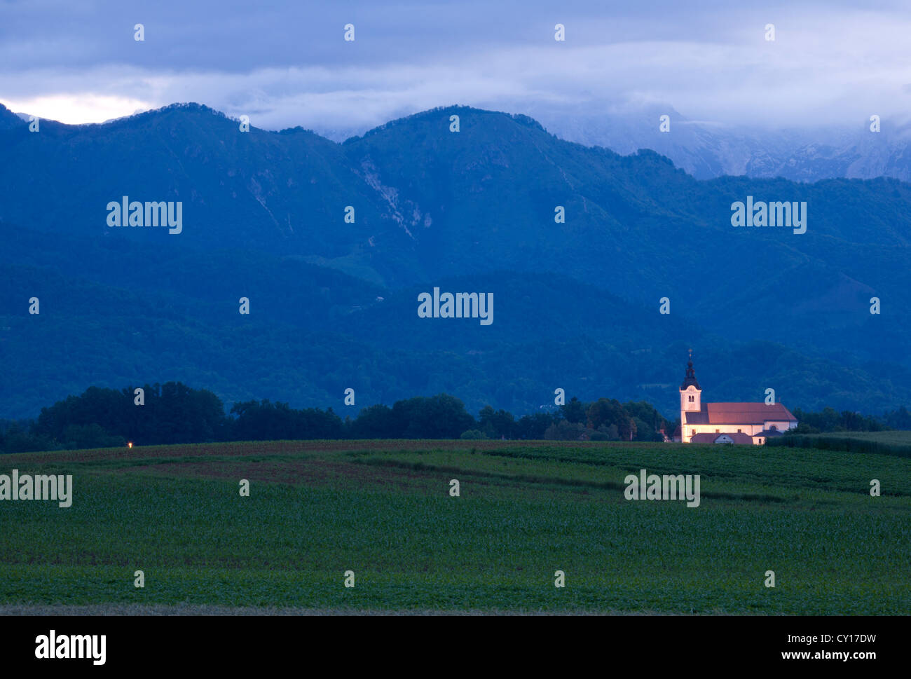 The church of Saint Peter lit at dawn and sitting in the shadow of the ...